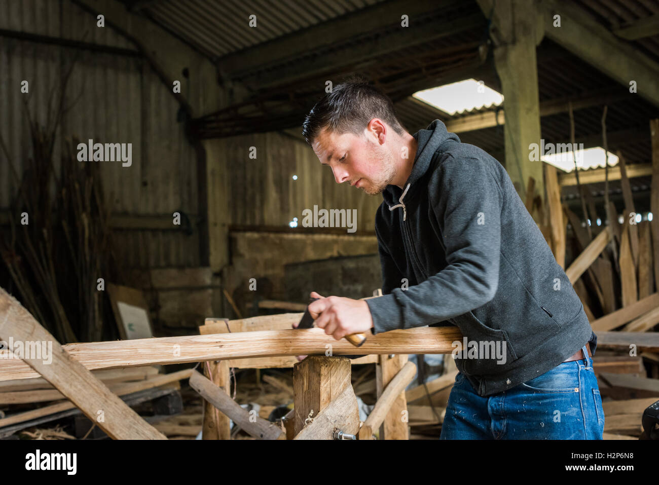Carpenter working on a piece of wood Stock Photo - Alamy