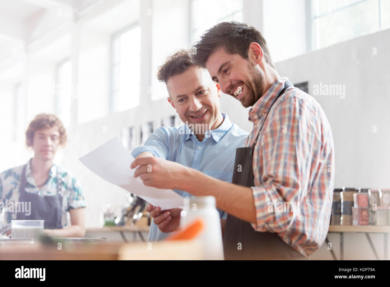 Male students with recipe in cooking class kitchen Stock Photo - Alamy