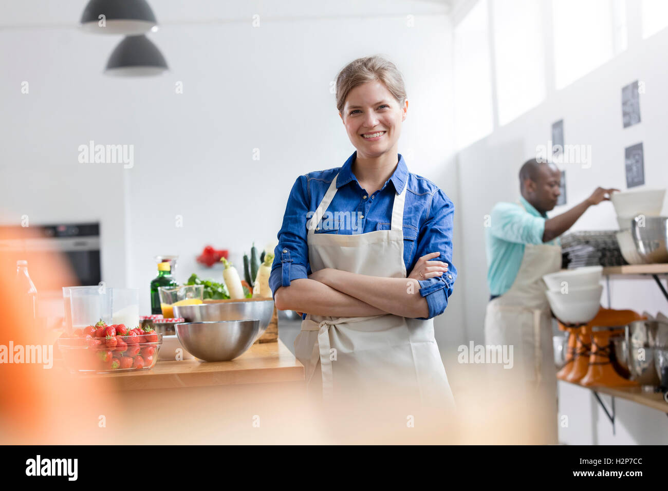 Portrait smiling female student in cooking class kitchen Stock Photo ...