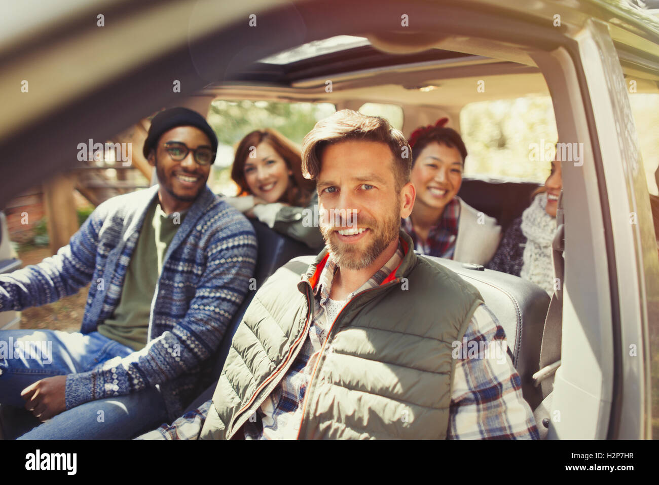 Portrait smiling friends inside car Stock Photo - Alamy