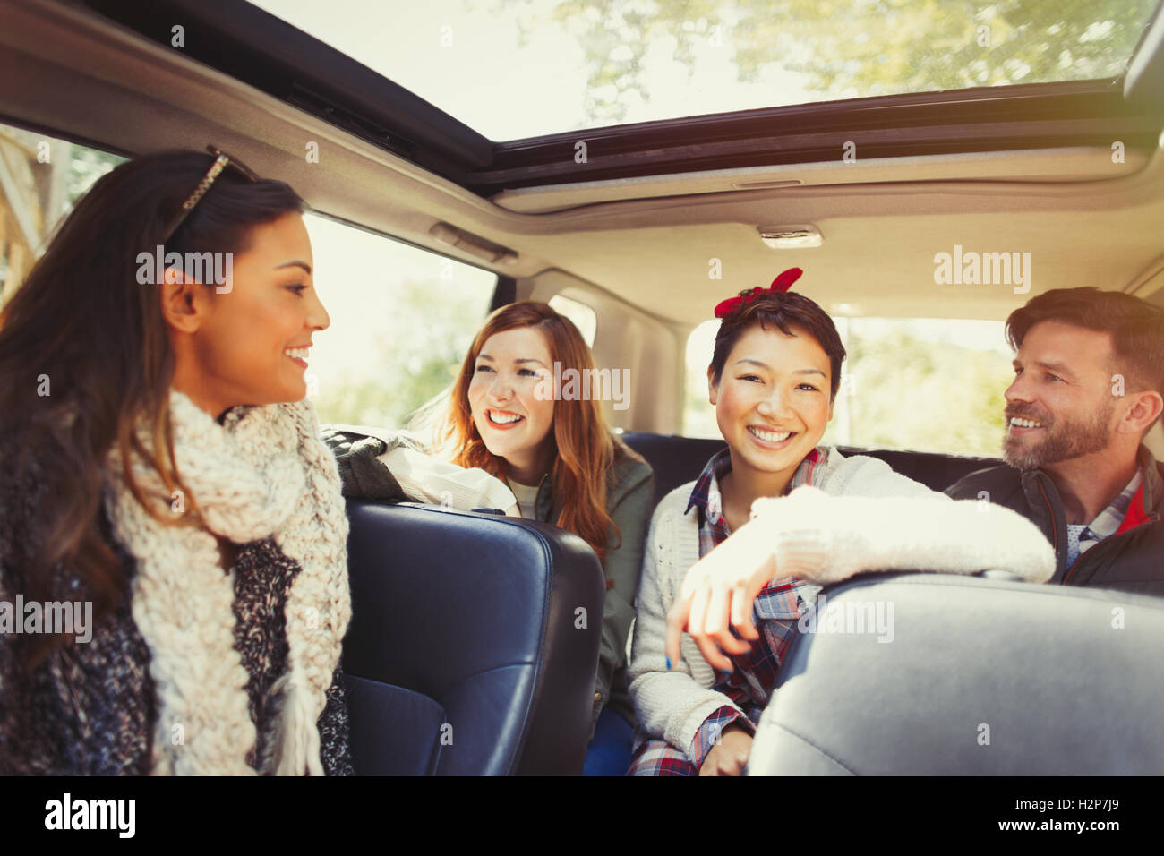 Friends talking and riding in car Stock Photo - Alamy
