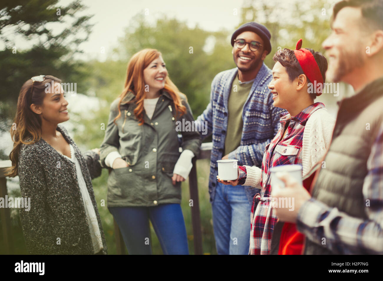 Friends talking and drinking coffee on balcony Stock Photo - Alamy