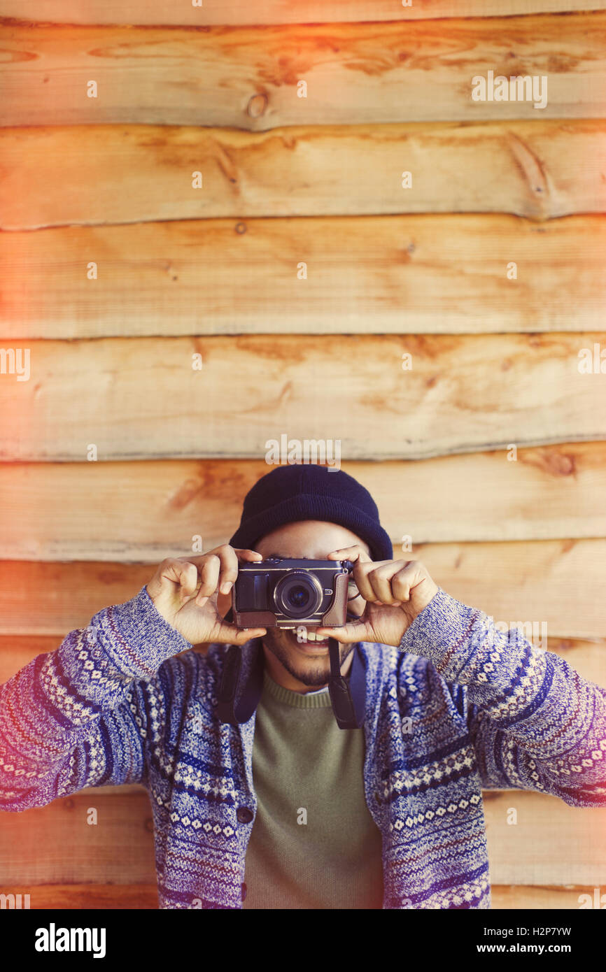 Portrait playful man using camera outside cabin Stock Photo - Alamy