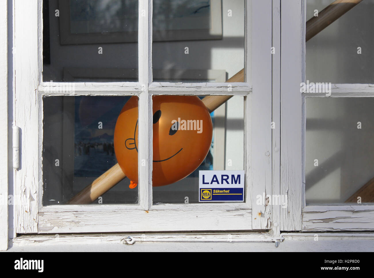 Happy balloon in a window Stock Photo - Alamy
