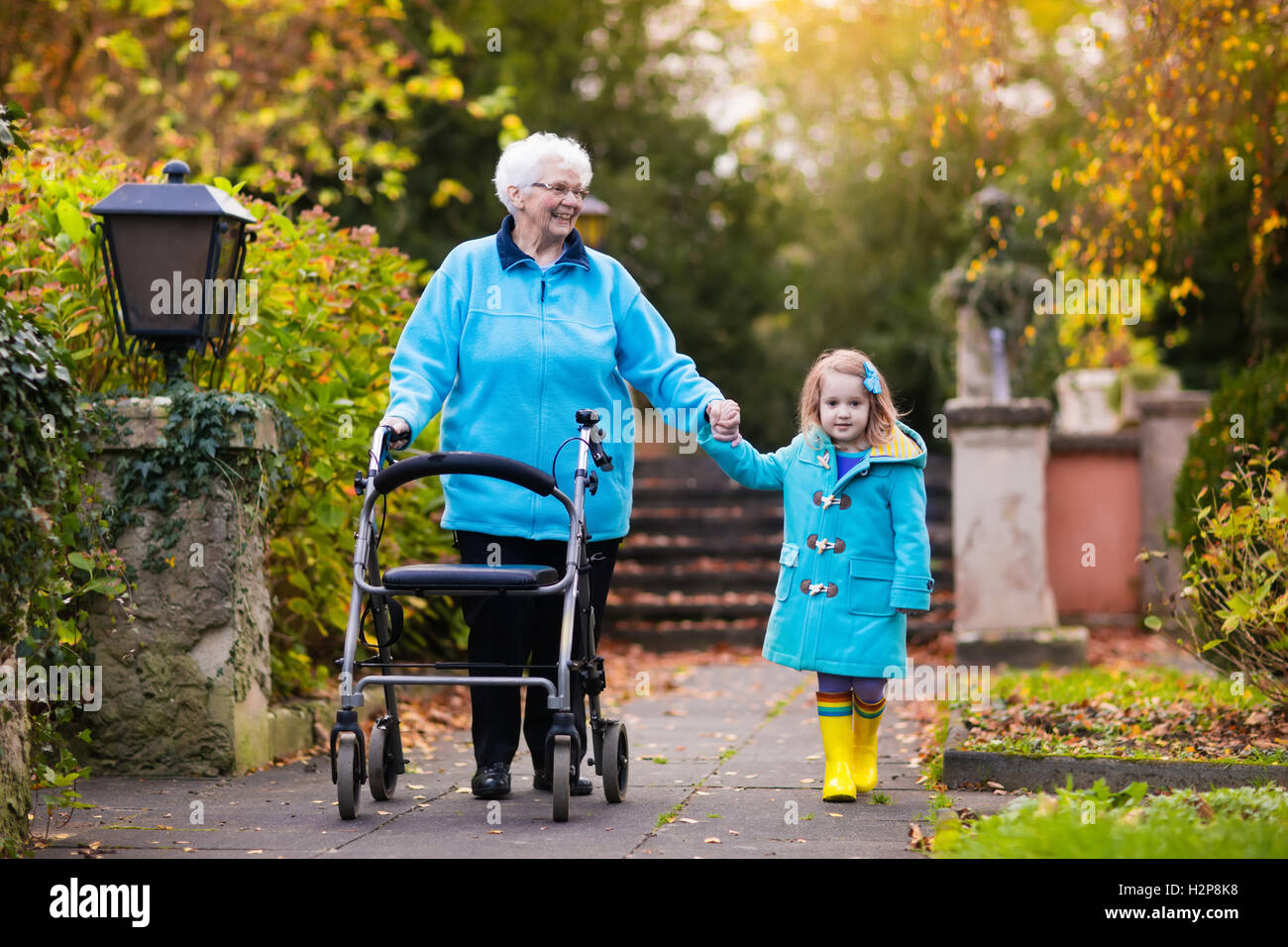 Happy senior lady with a walker or wheel chair and children ...