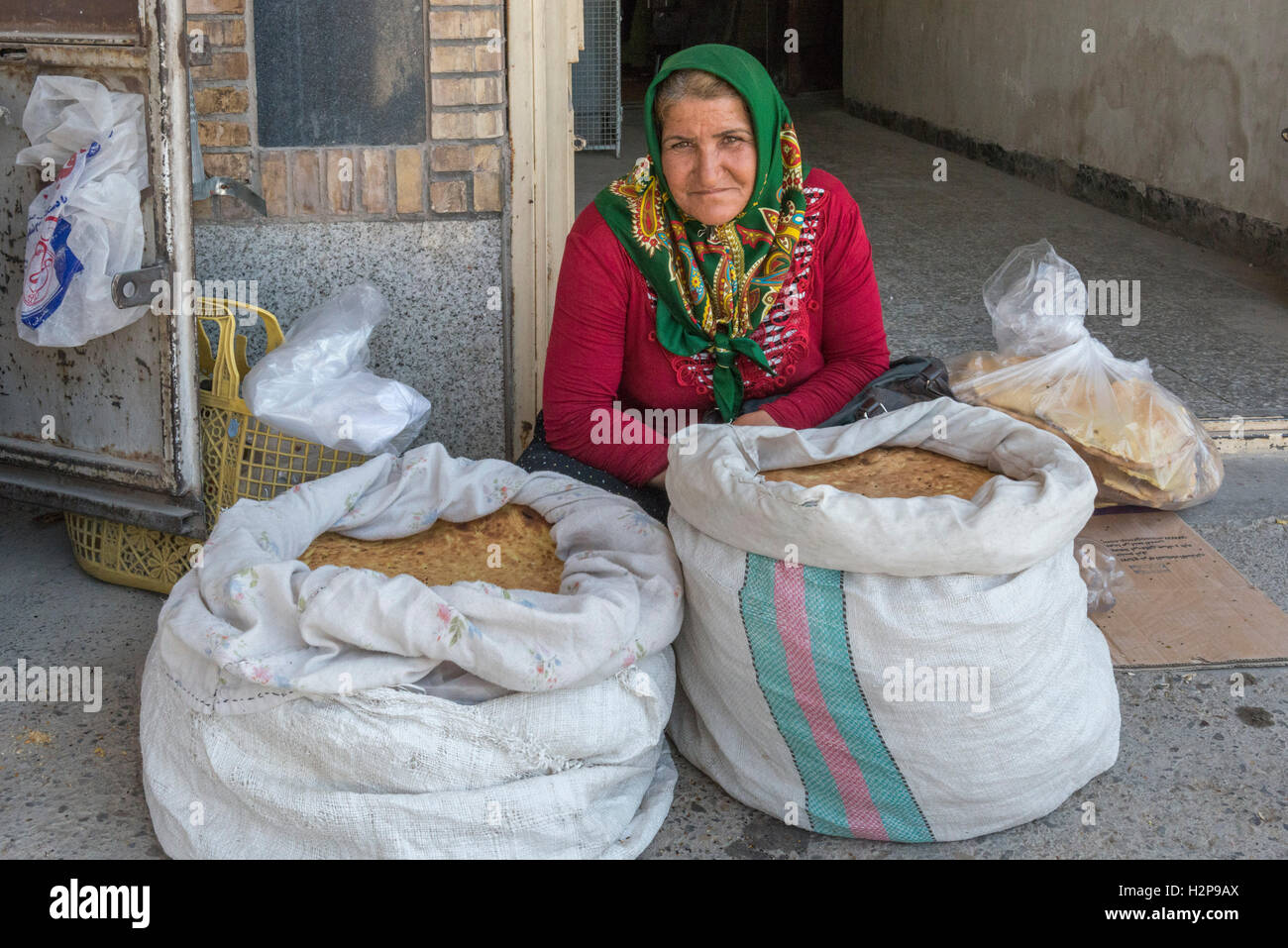 Kerman, Bazaar, Lady Selling Bread In White Bags Stock Photo - Alamy