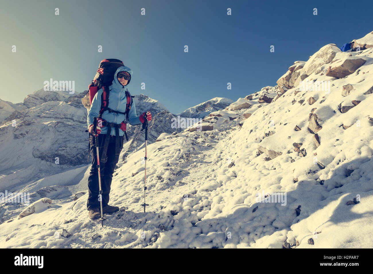 Happy trekker resting on her ascend Stock Photo - Alamy