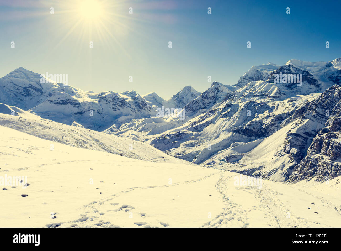 Snow covered path across mountain landscape Stock Photo - Alamy
