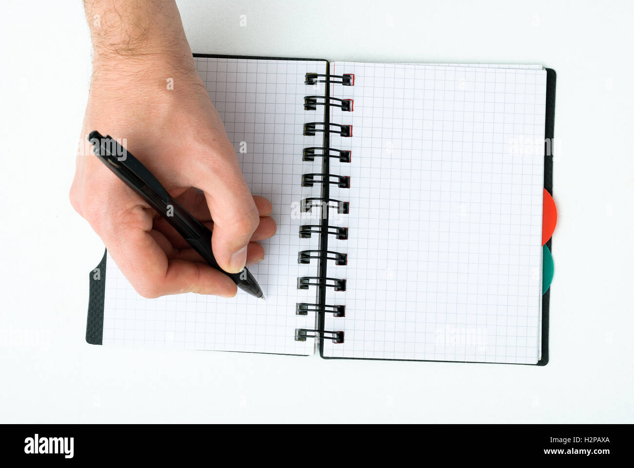 Hand writing on empty notepad Stock Photo - Alamy