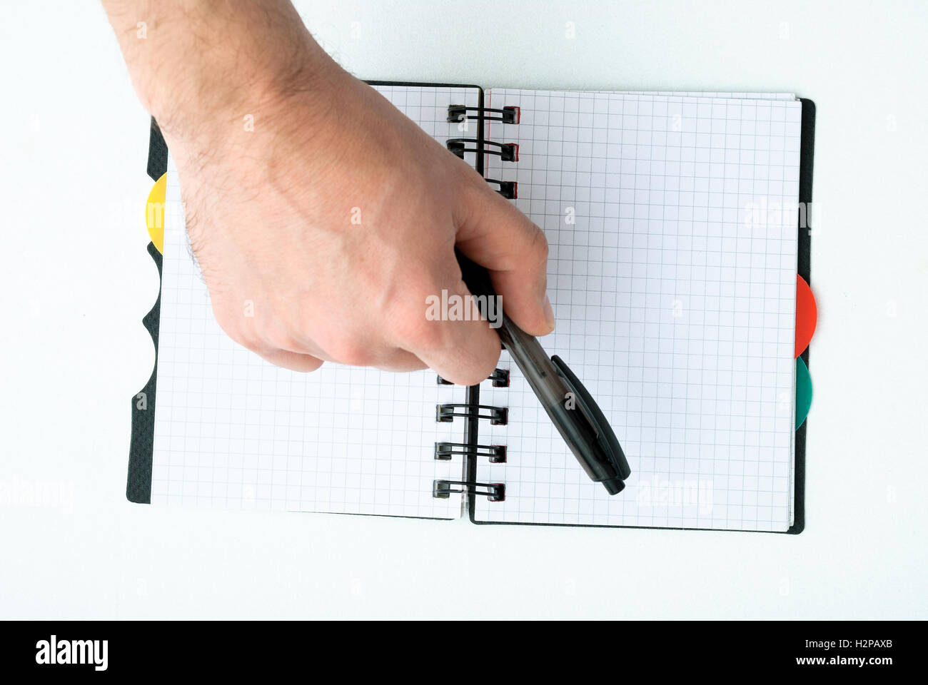 Hand writing on empty notepad Stock Photo - Alamy