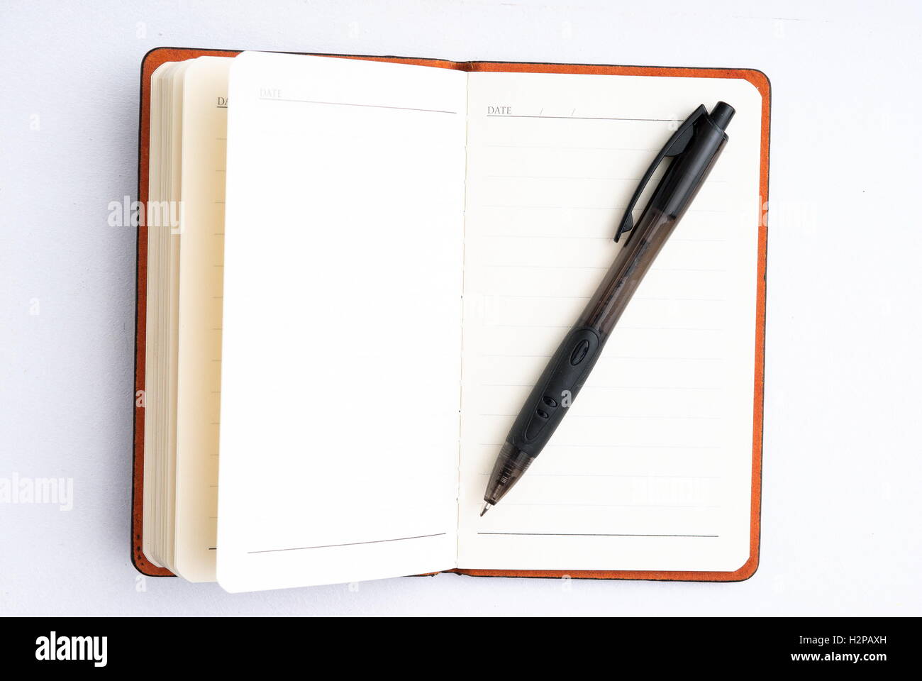 notepad with pen isolated Stock Photo - Alamy