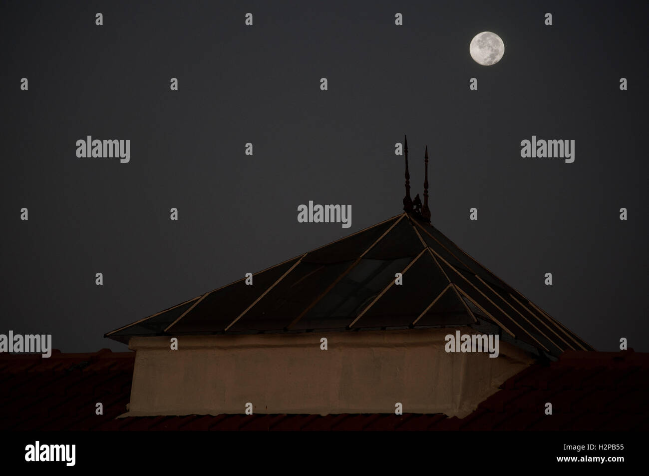 Full moon over the roof Stock Photo - Alamy