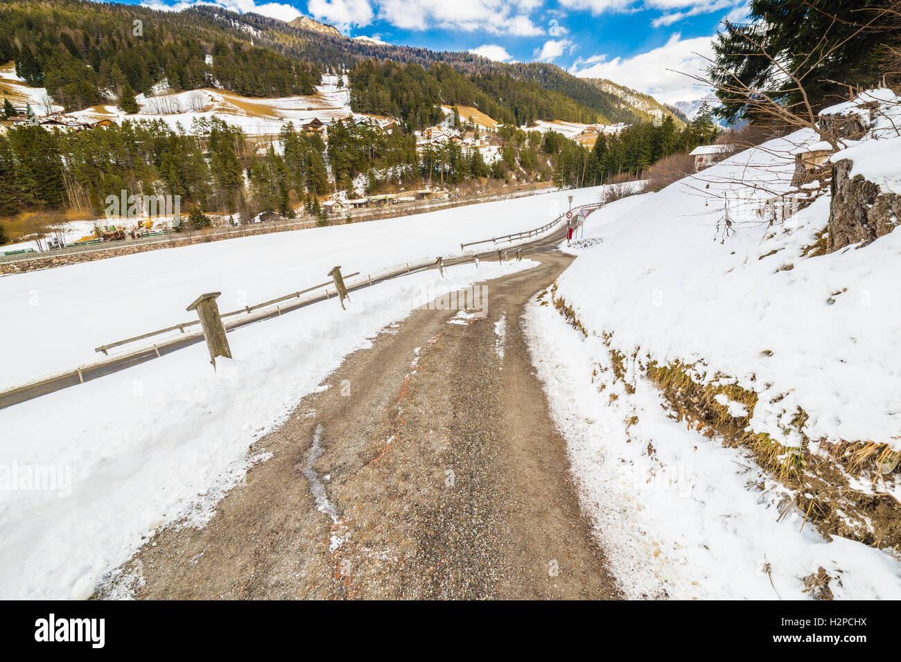 country road leading through a winter mountain landscape Stock Photo ...