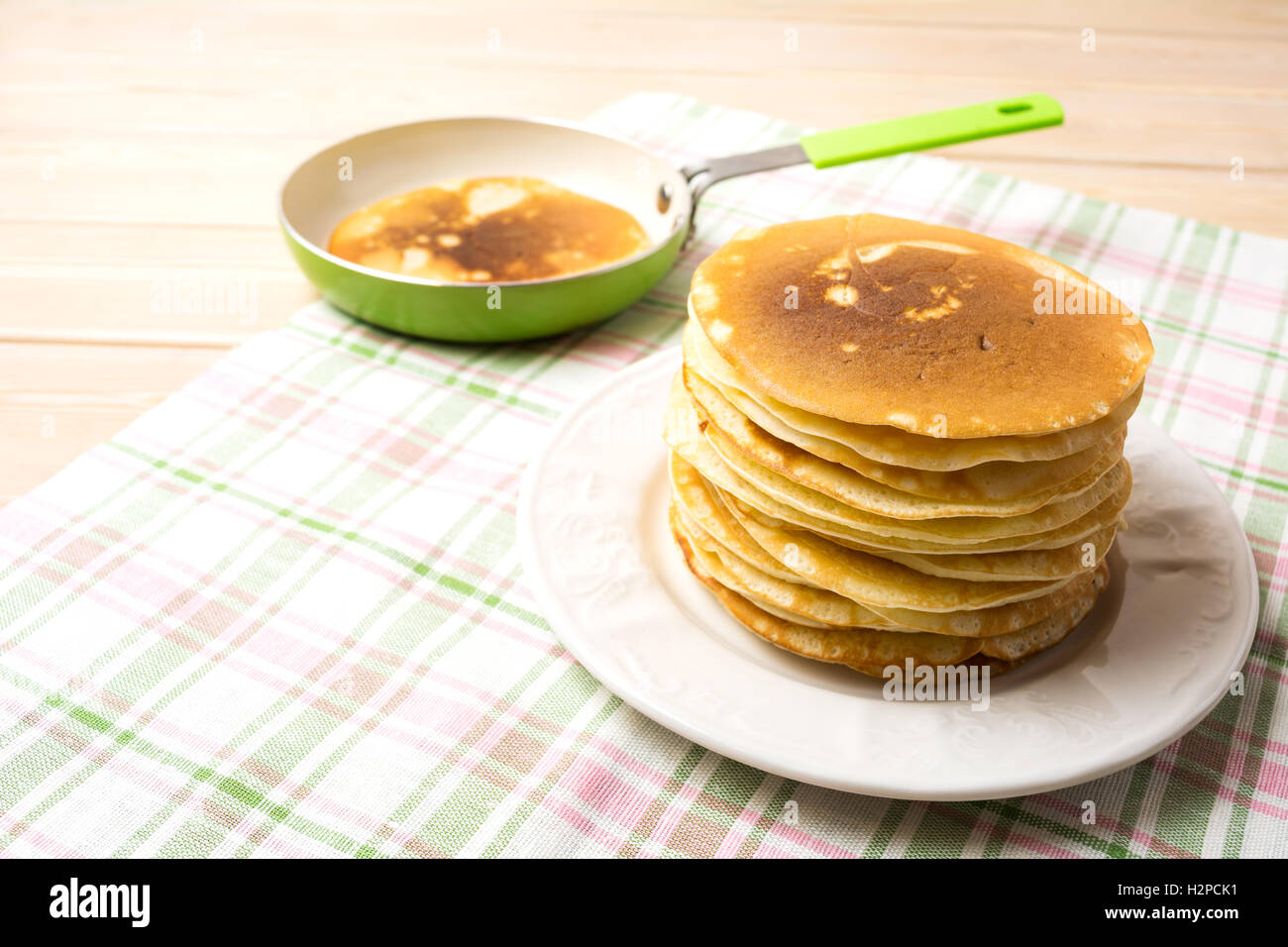 Stack of homemade breakfast pancakes and green pan. Homemade pancakes ...