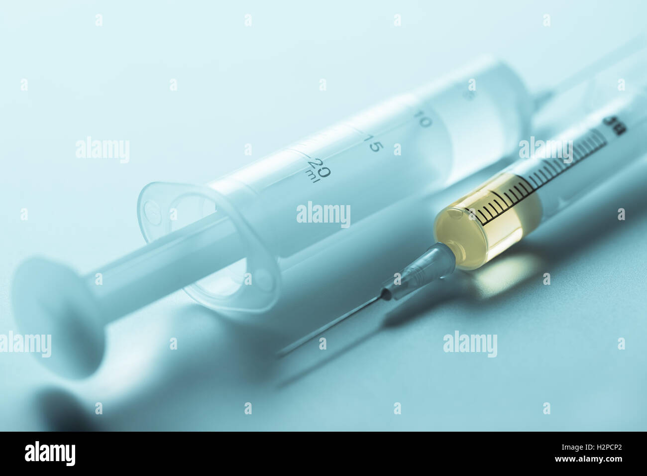 Two medical syringe close-up with a medical product Stock Photo - Alamy