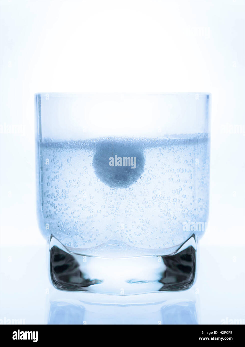 aspirin tablet in a glass of water, white background Stock Photo - Alamy