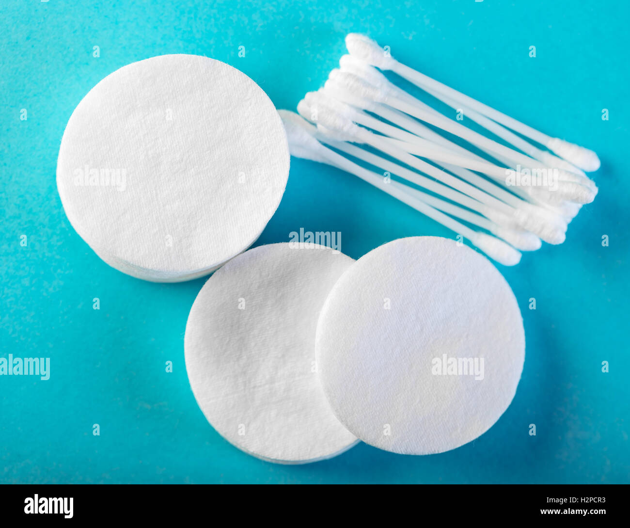 cotton pads and sticks on blue background Stock Photo - Alamy