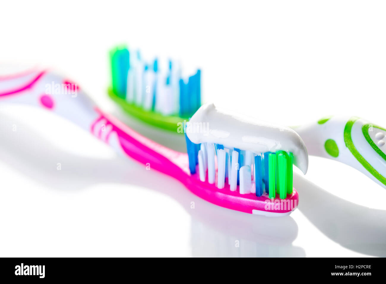 two toothbrushes closeup on against white background Stock Photo - Alamy