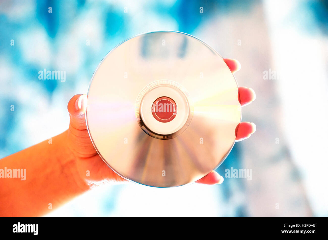 hand holding a DVD disc Stock Photo - Alamy