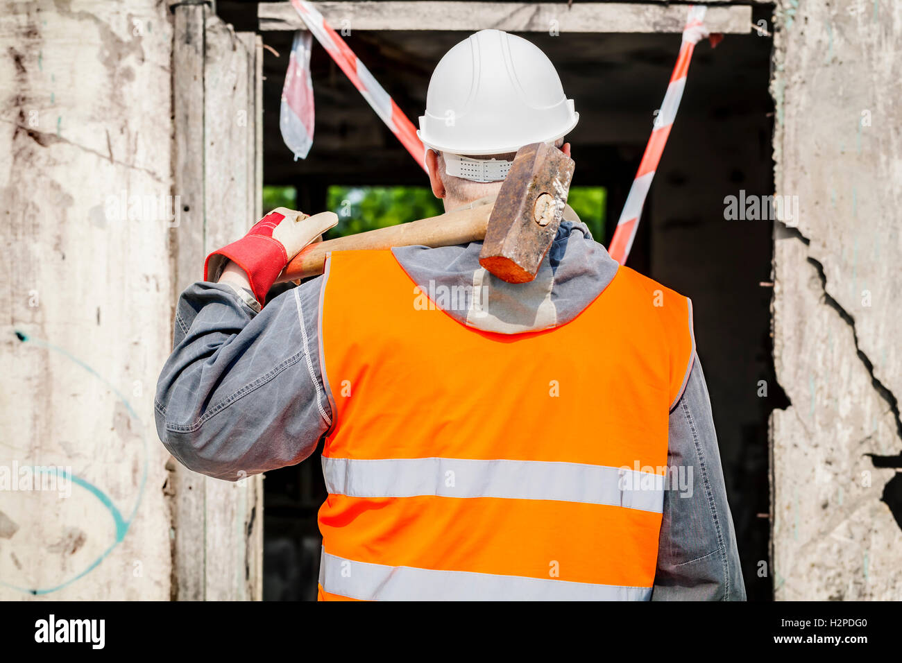 Construction worker with sledge hammer Stock Photo - Alamy