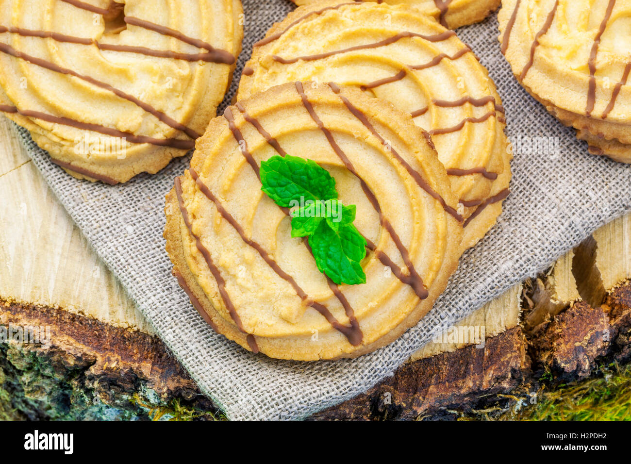 Cookies with chocolate lines on linen and wood Stock Photo - Alamy