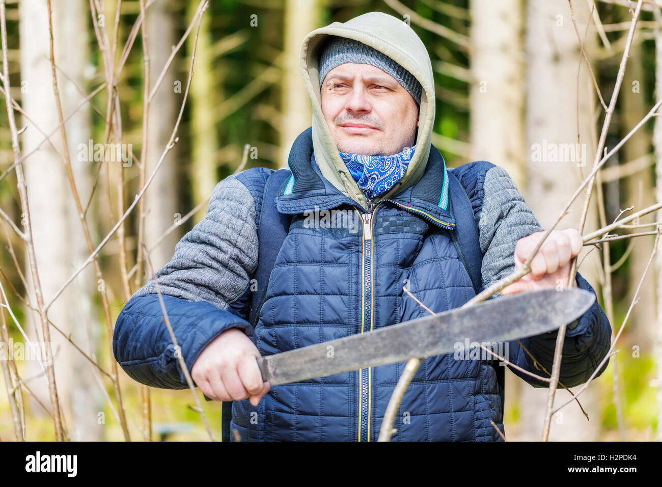 Hiker with machete in forest Stock Photo - Alamy