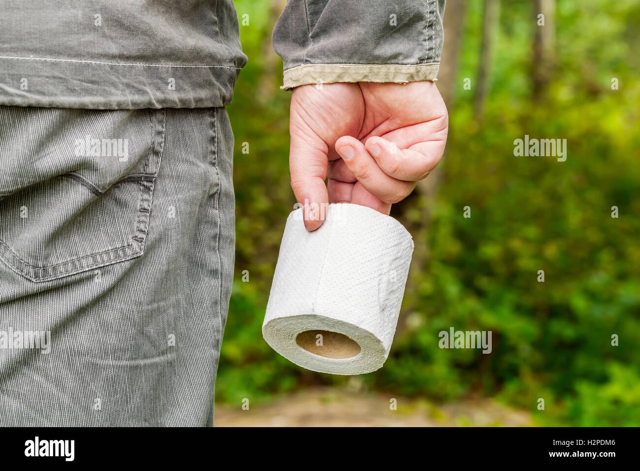 Man holding toilet paper Stock Photo - Alamy