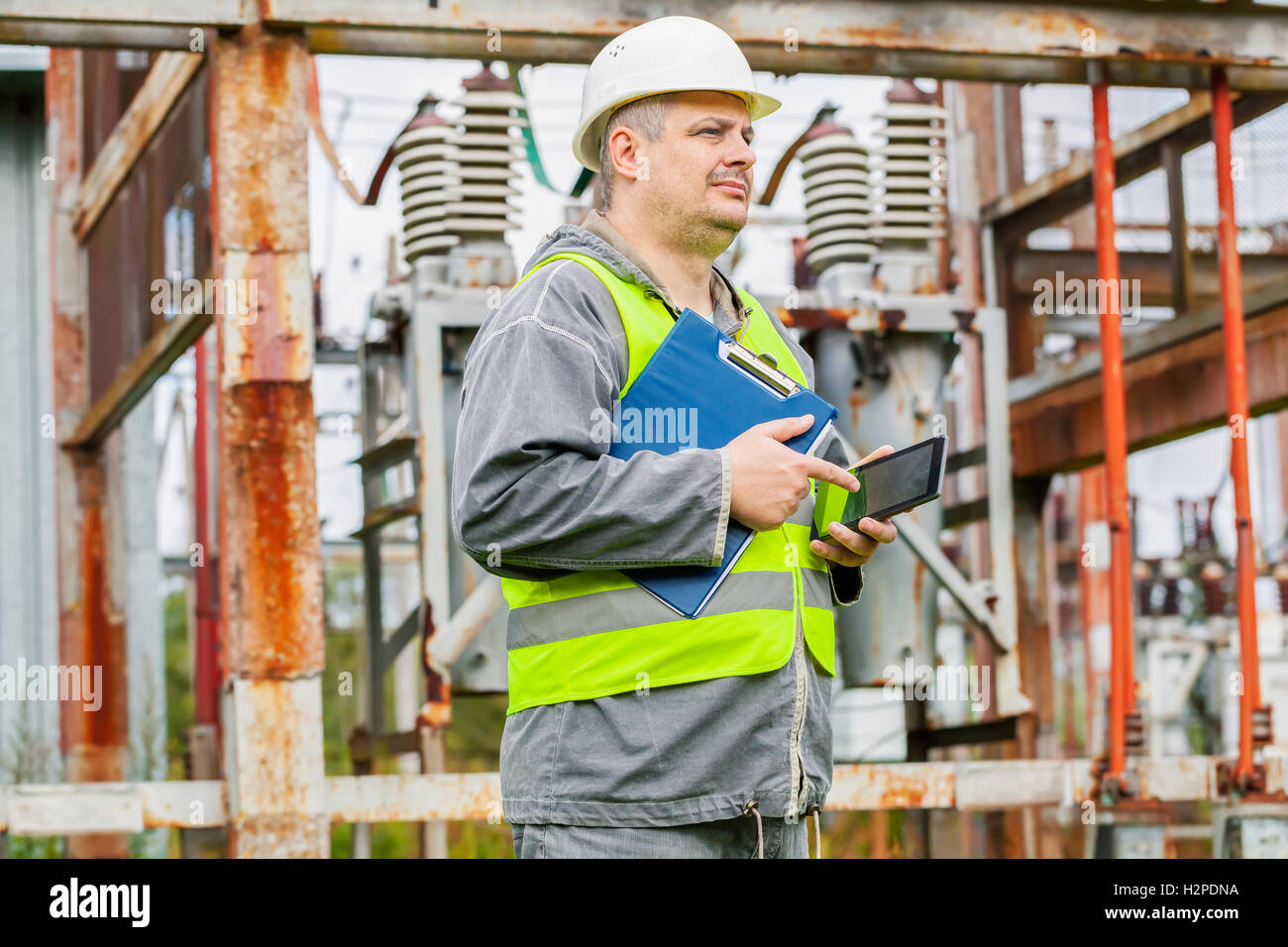 Electrician using tablet PC in electrical substation Stock Photo - Alamy