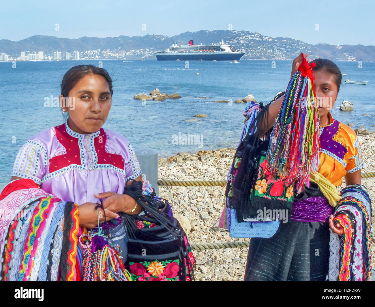 Two Mexican women on a shore with traditional clothing and souvenirs in ...