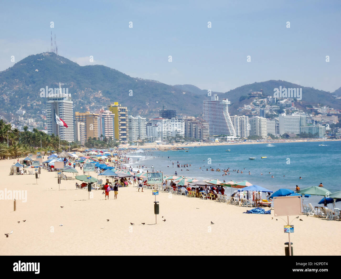 ACAPULCO, MEXICO - MARCH 11, 2006 : People on the beach with a view of ...