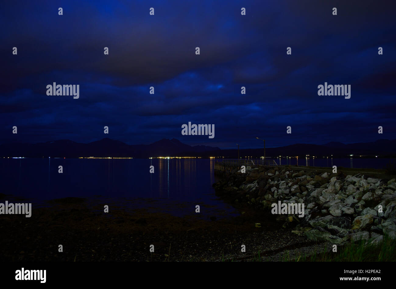 stone pier going into the dark blue fjord at dawn Stock Photo - Alamy