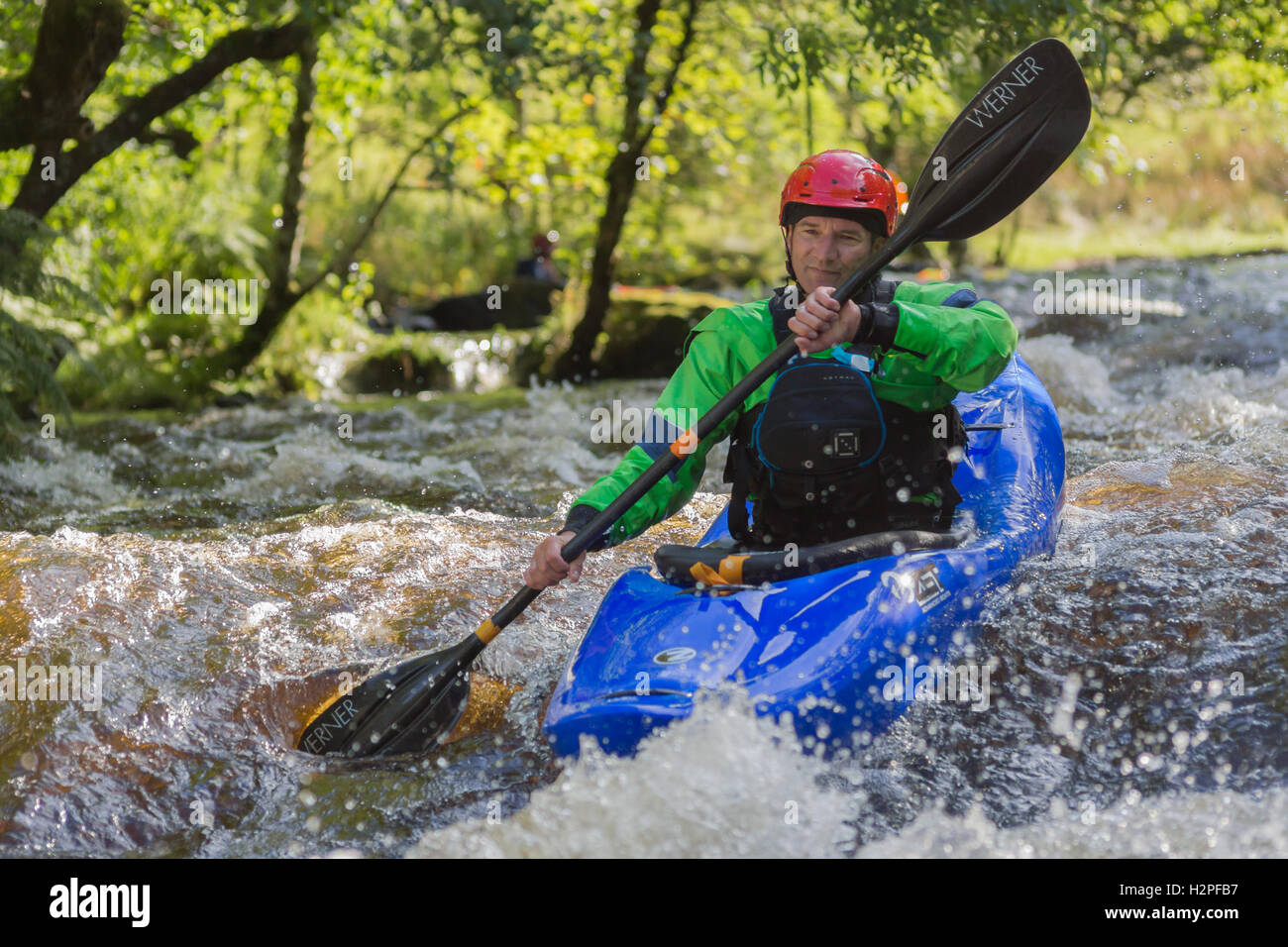 White water kayaker at the National White Water Centre canoeing through ...