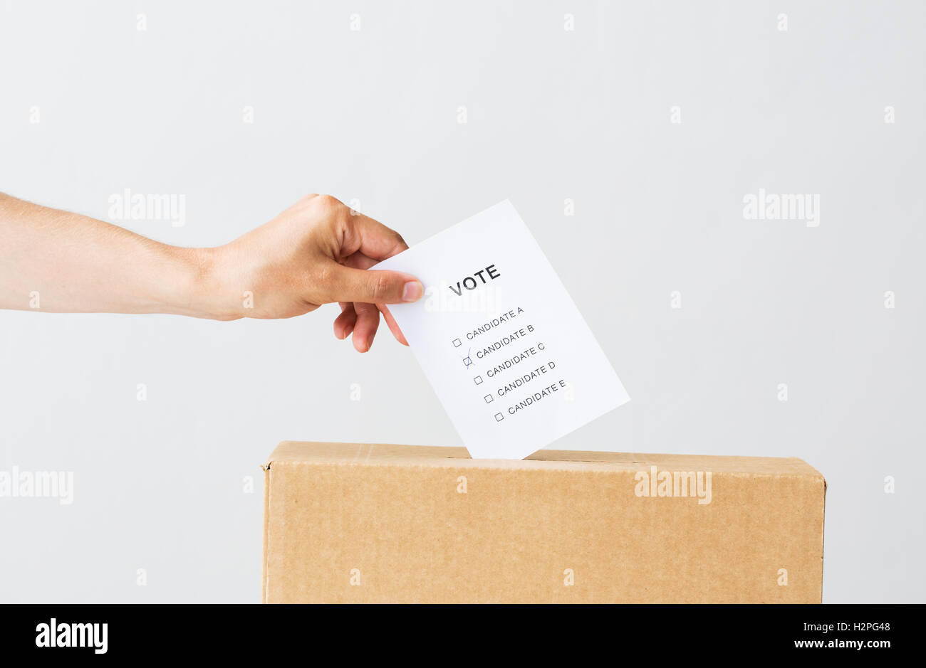 man putting his vote into ballot box on election Stock Photo - Alamy