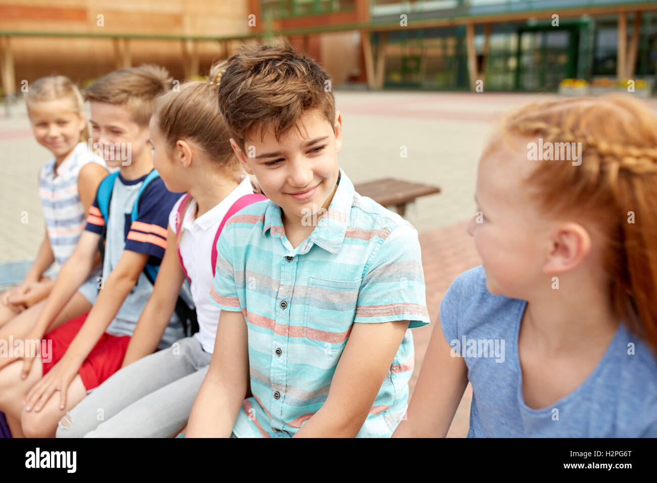group of happy elementary school students talking Stock Photo - Alamy