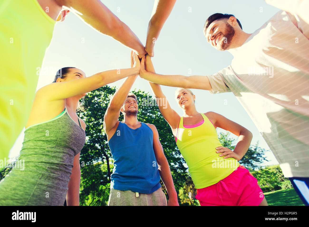 group of happy friends making high five outdoors Stock Photo - Alamy
