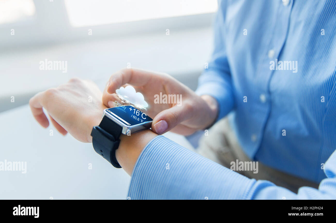 close up of hands with weather cast on smart watch Stock Photo - Alamy
