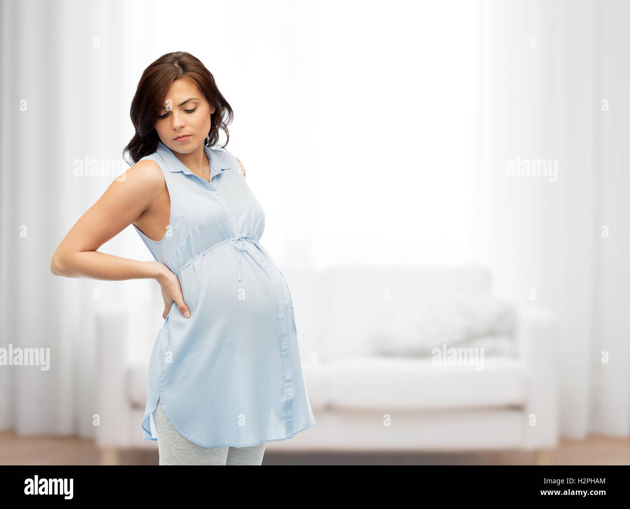 pregnant woman with backache Stock Photo - Alamy