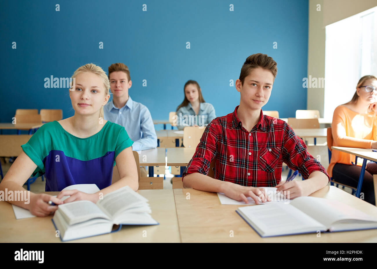 group of students with books at school lesson Stock Photo - Alamy