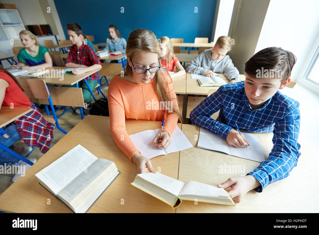 students reading book at school lesson Stock Photo - Alamy