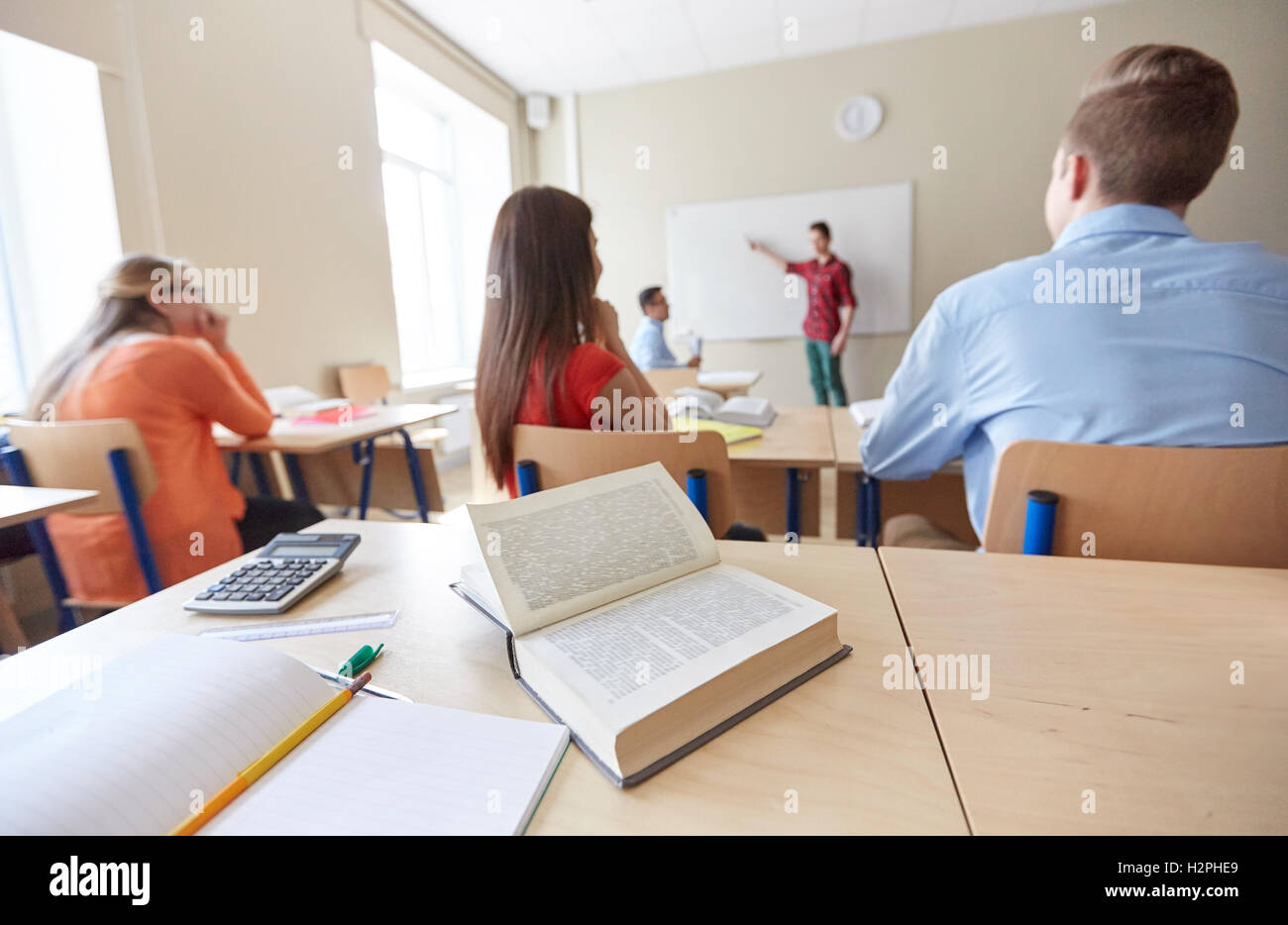 teacher and student at white board in school Stock Photo - Alamy