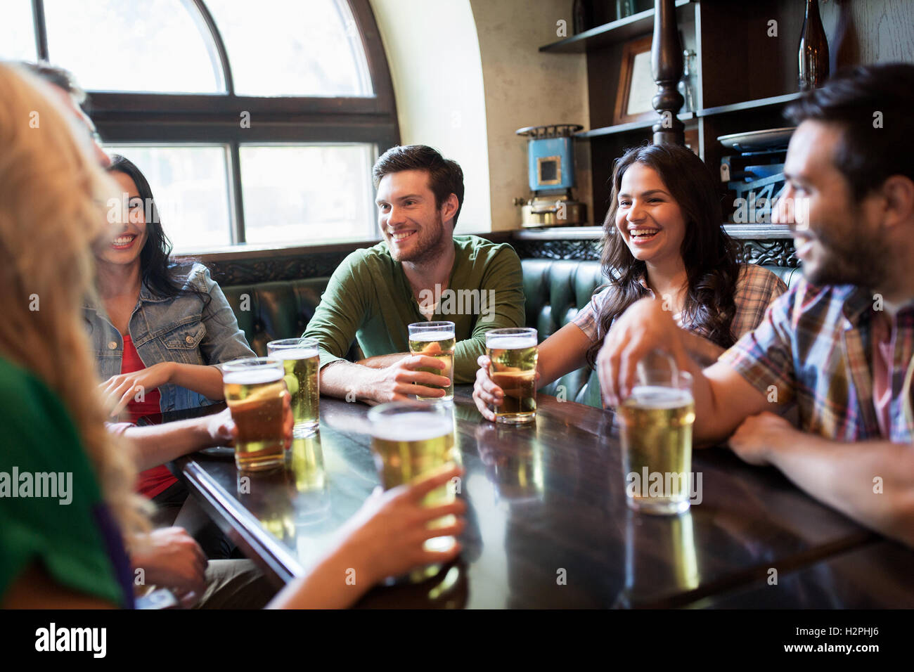 happy friends drinking beer at bar or pub Stock Photo - Alamy