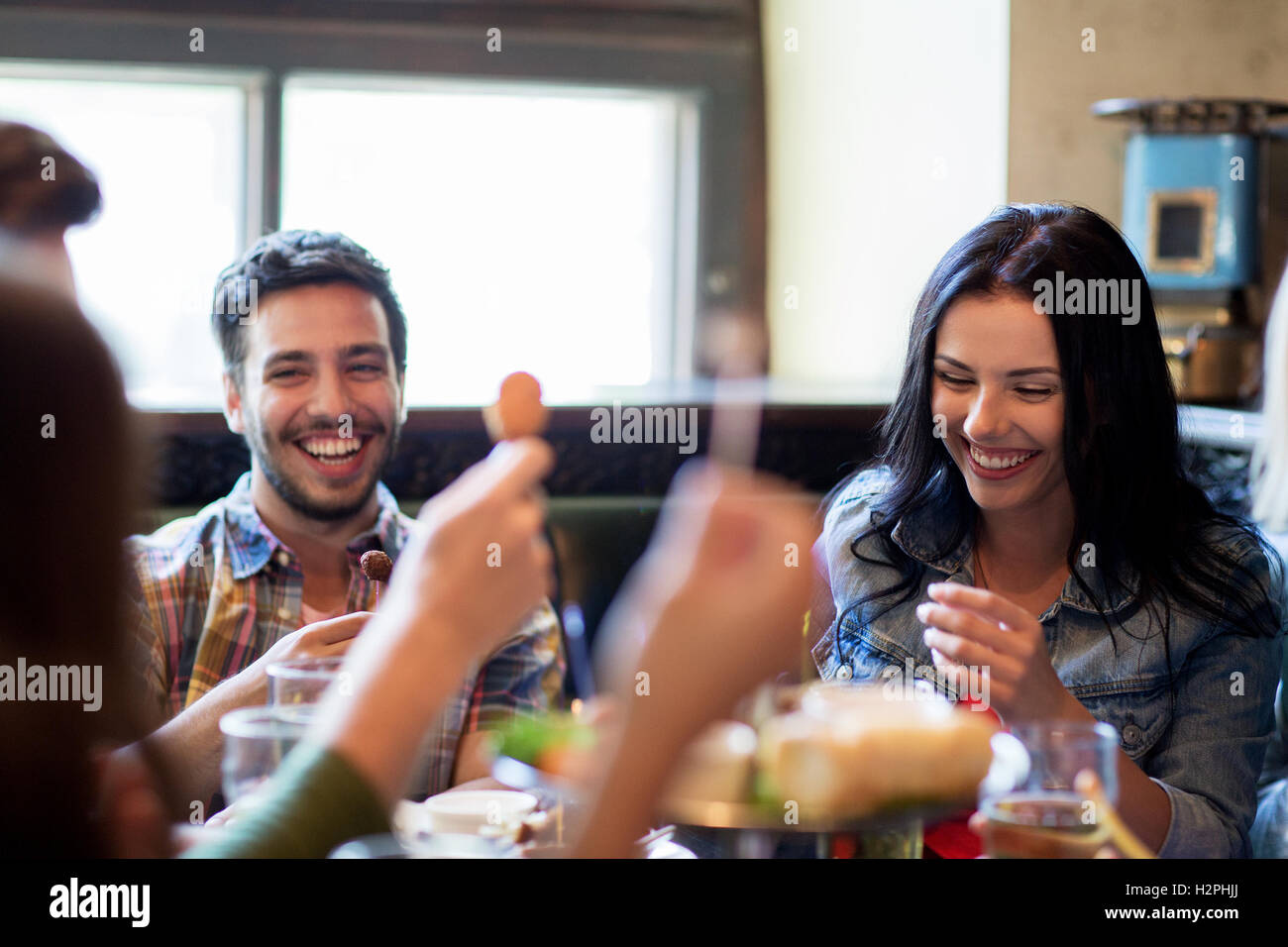 Happy friends eating drinking smiling hi-res stock photography and ...