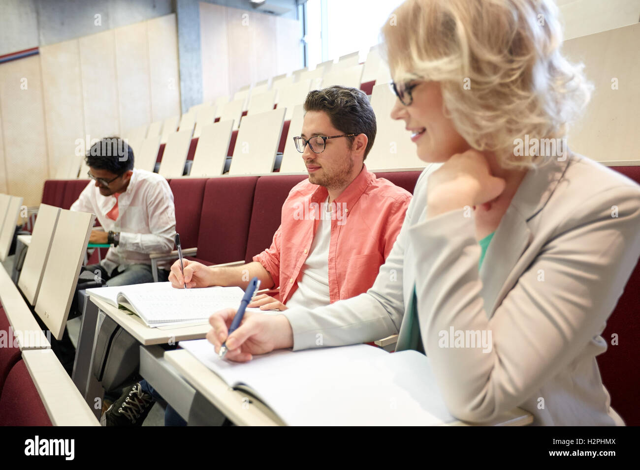 group of students with notebooks at lecture hall Stock Photo - Alamy
