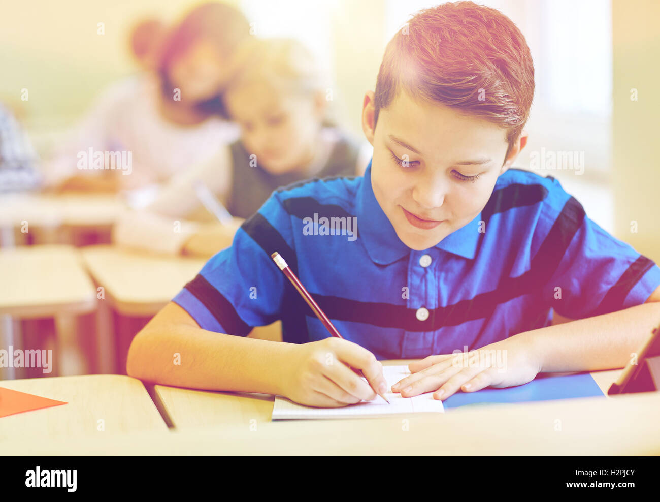 group of school kids writing test in classroom Stock Photo - Alamy