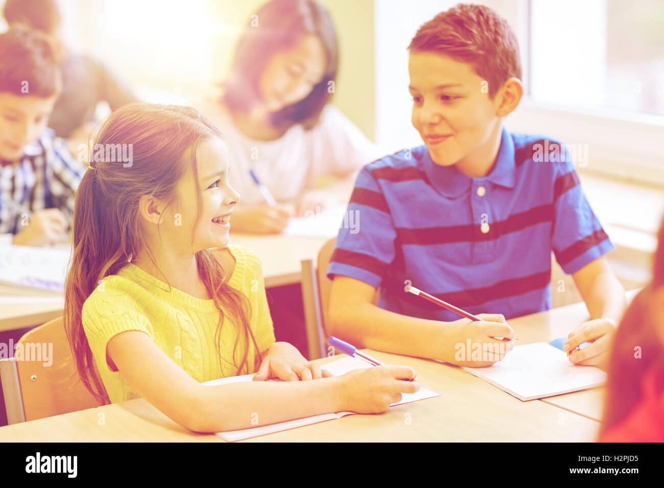 group of school kids writing test in classroom Stock Photo - Alamy