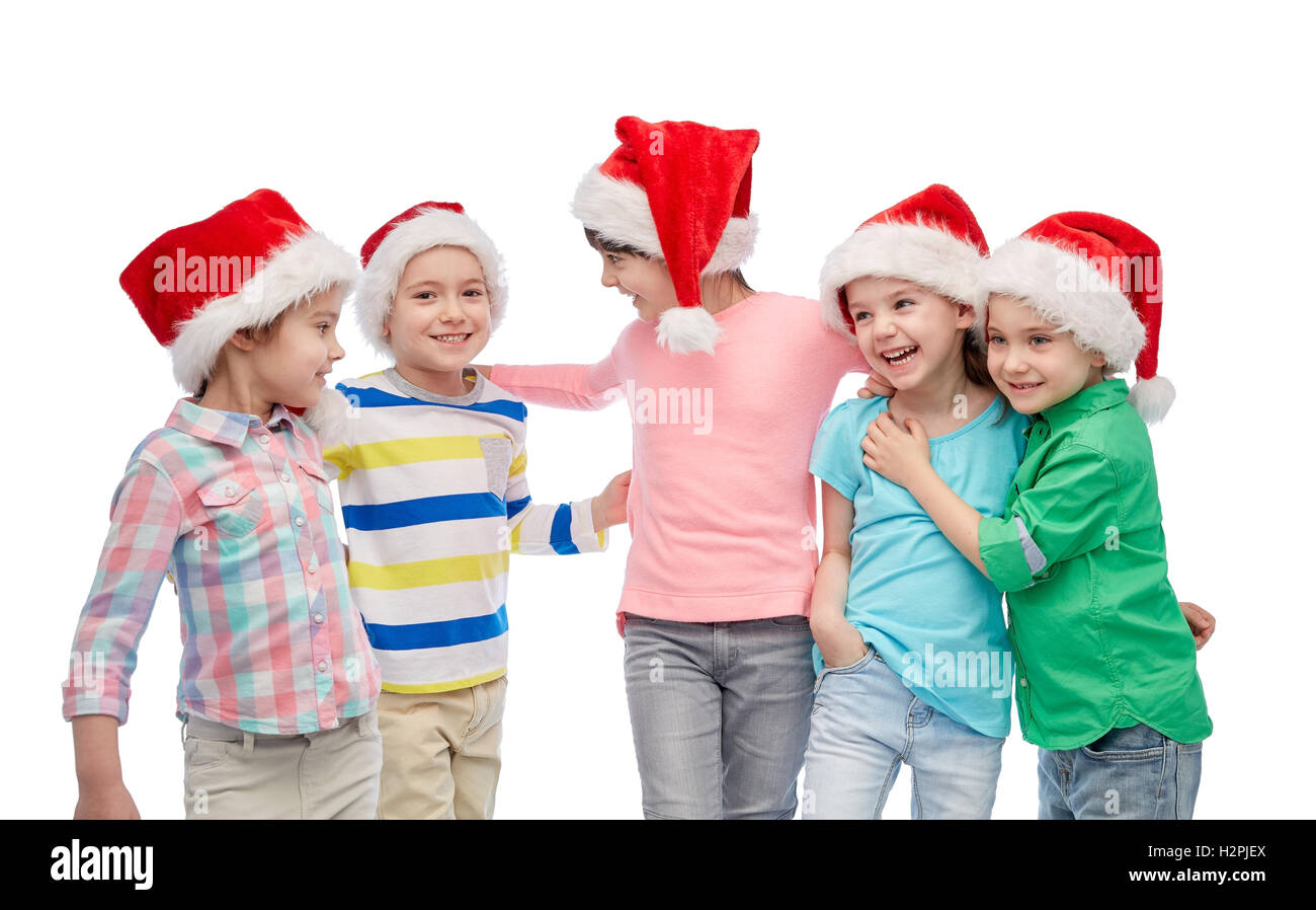 happy little children in santa hats hugging Stock Photo - Alamy
