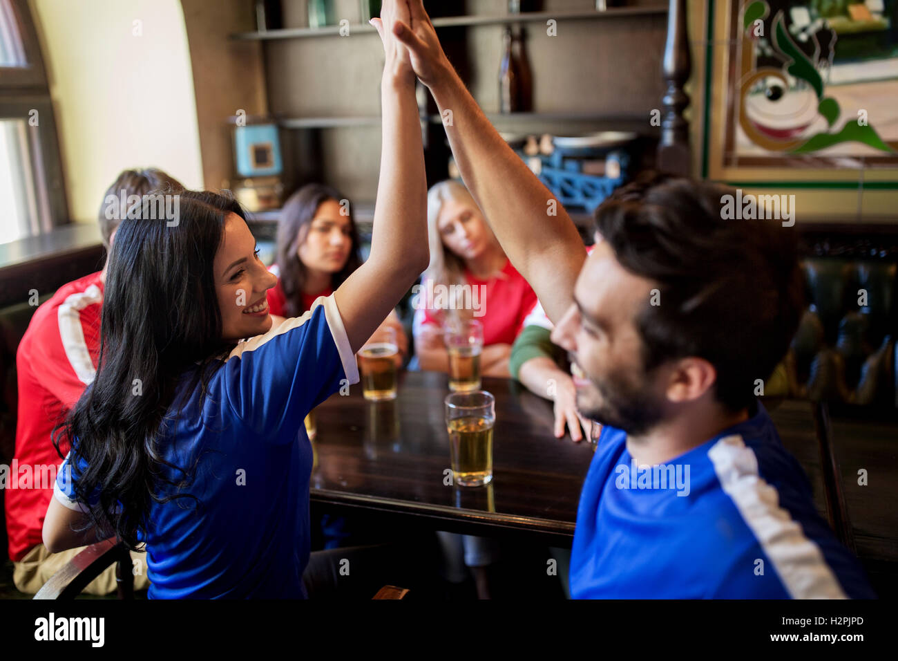 football fans with beer celebrating victory at bar Stock Photo - Alamy
