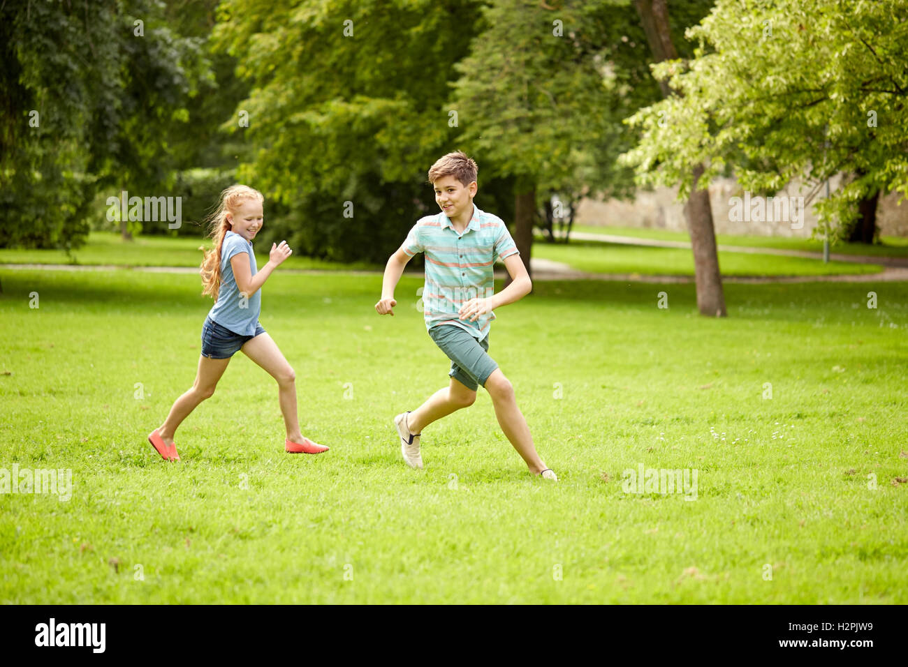 happy kids running and playing game outdoors Stock Photo - Alamy