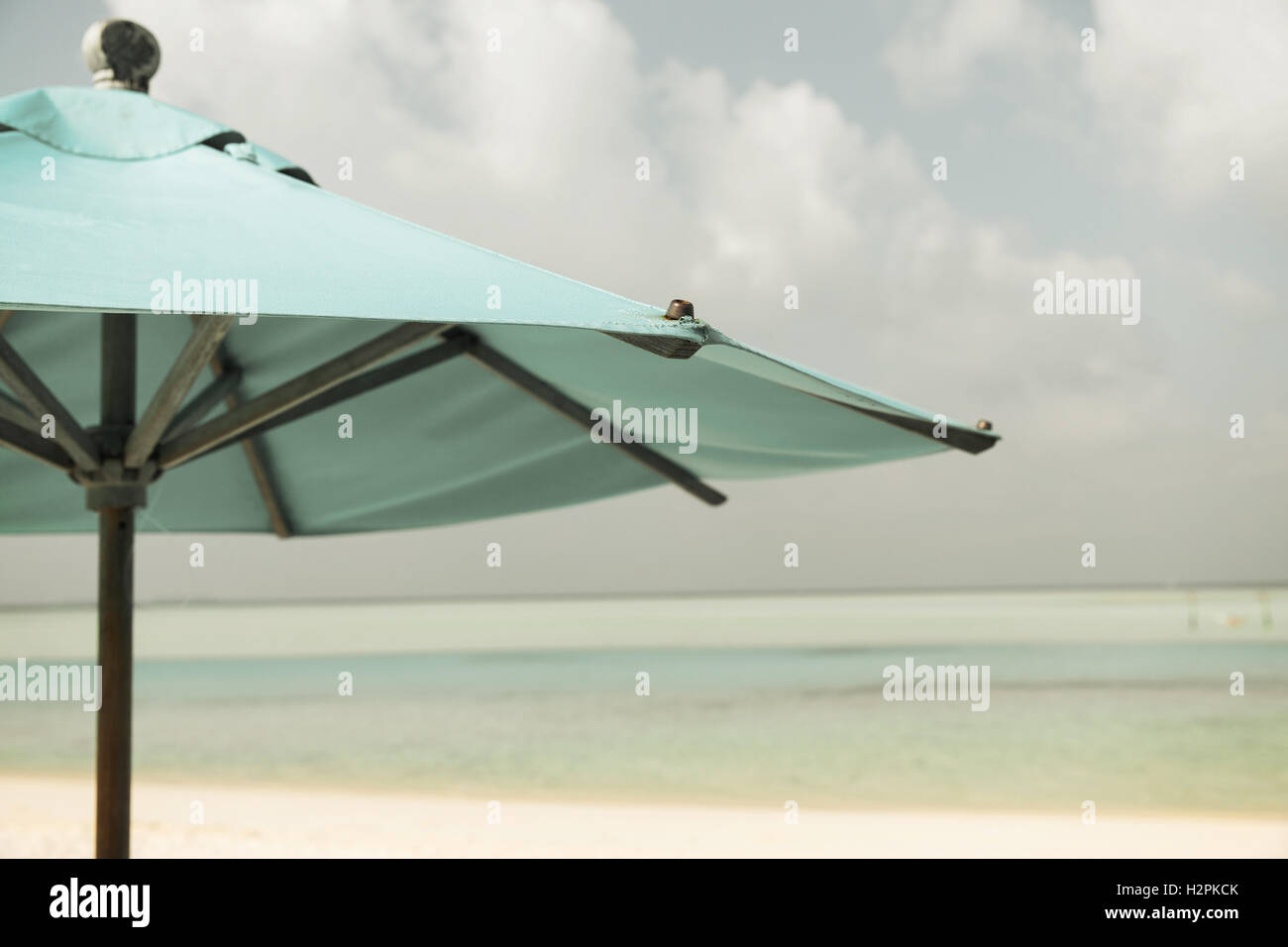 parasol over blue sky and beach Stock Photo - Alamy