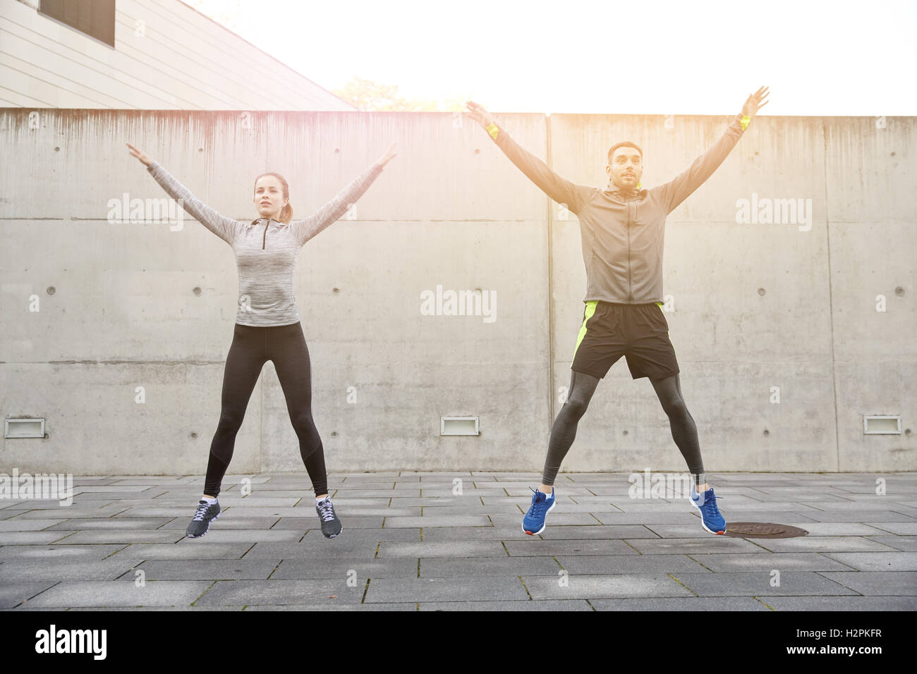 happy man and woman jumping outdoors Stock Photo - Alamy